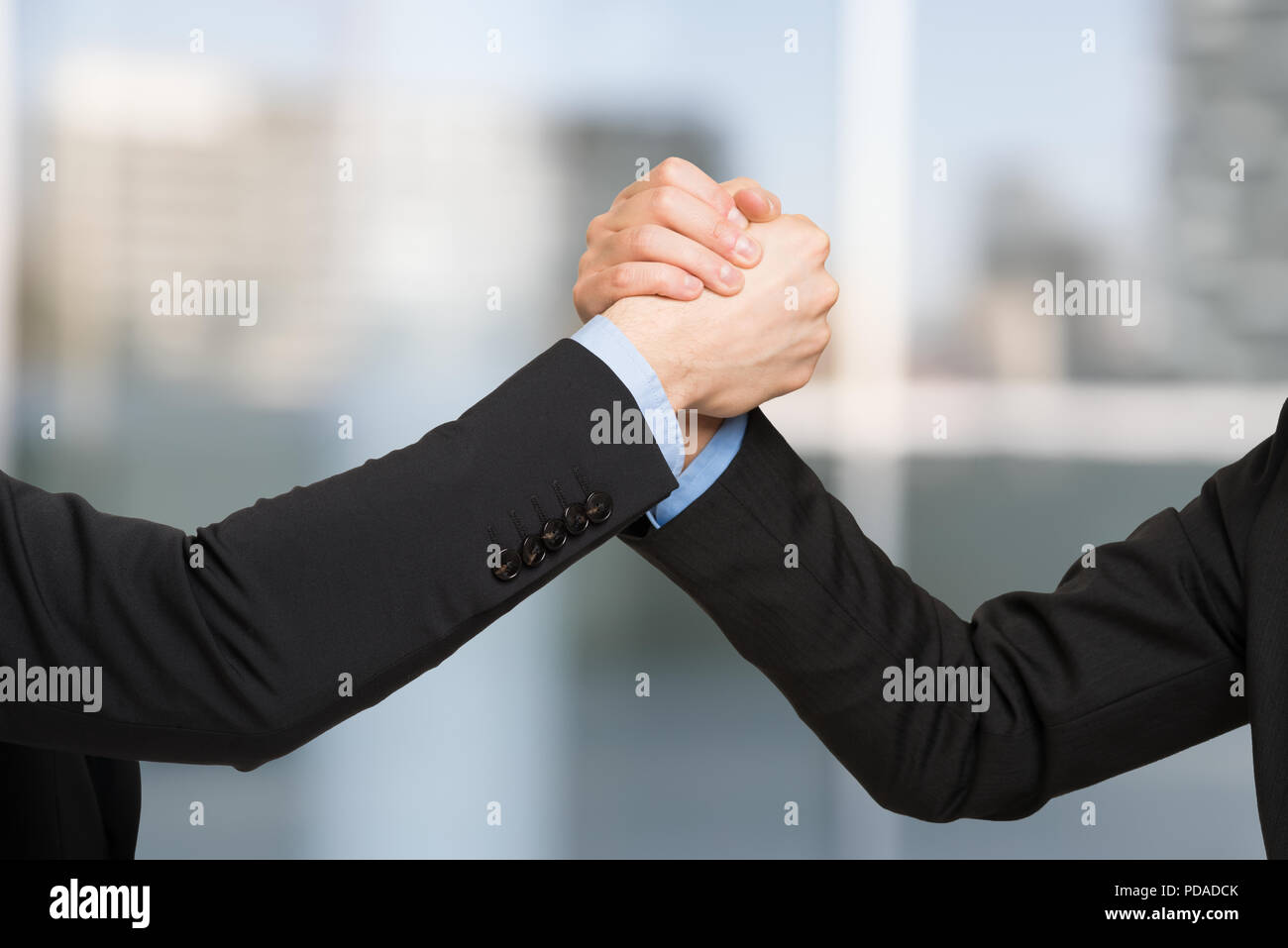 Powerful handshake between business people Stock Photo - Alamy