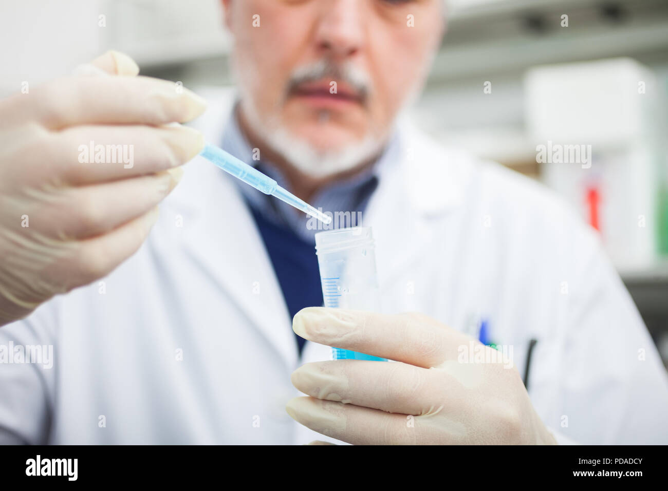 Portrait of a scientist holding liquid in a flask hi-res stock ...