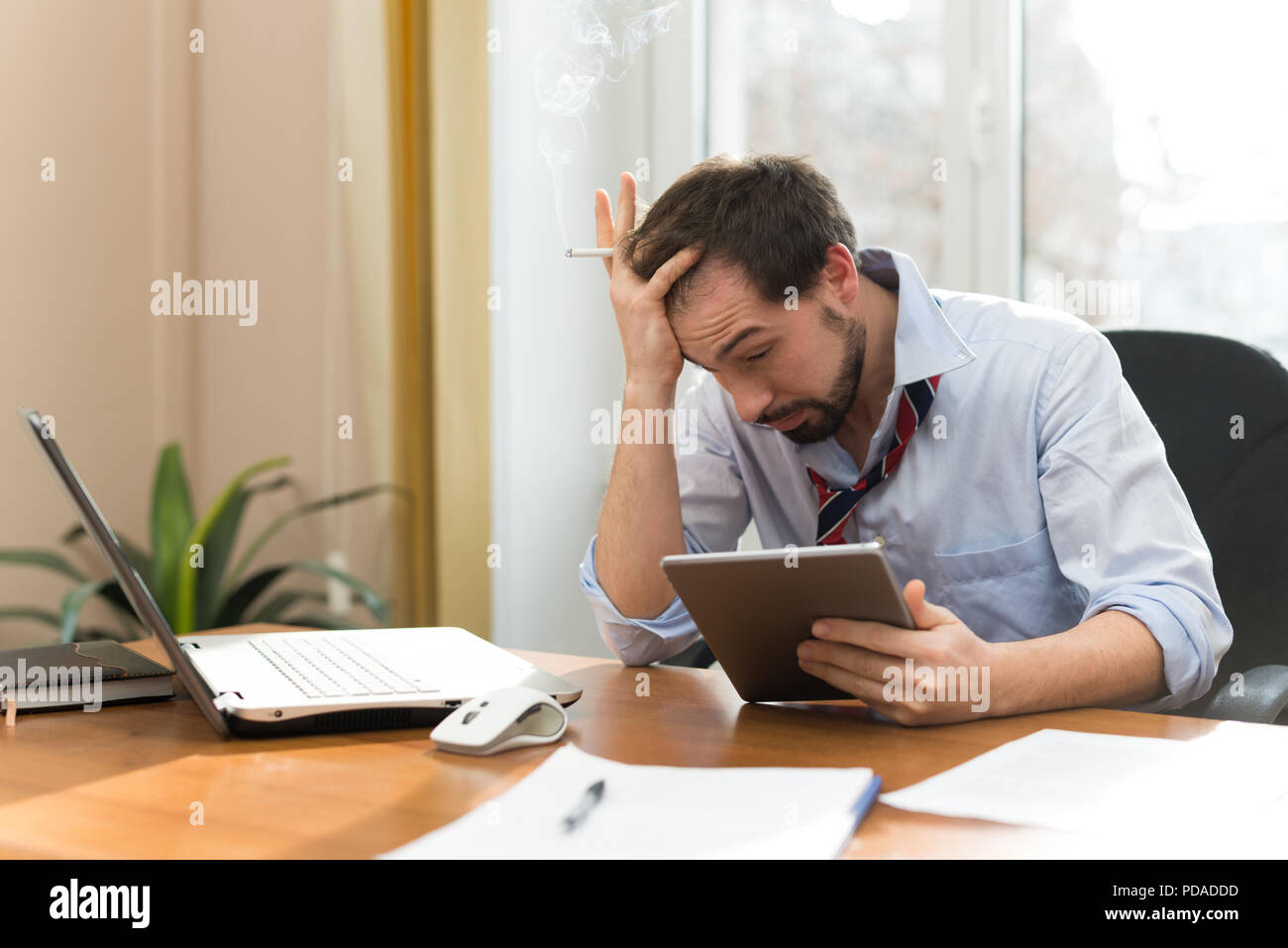 Stressed businessman at work Stock Photo - Alamy