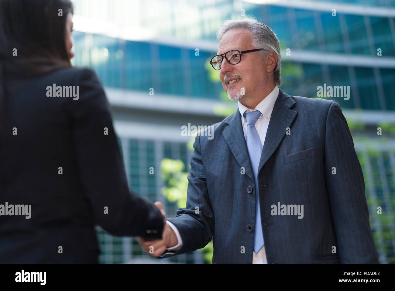 Business people handshake outdoor Stock Photo - Alamy