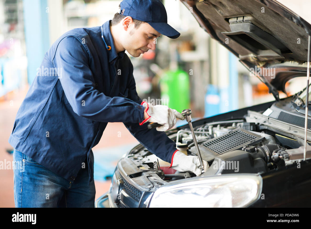 Portrait of an auto mechanicin front of a car in his garage Stock Photo ...