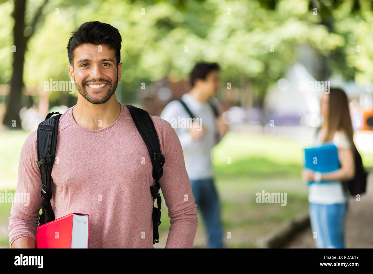 Happy students outdoor smiling Stock Photo - Alamy