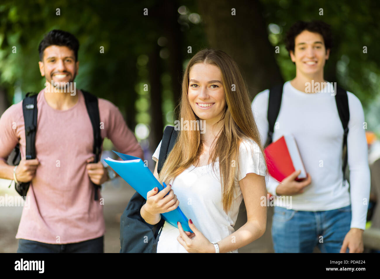 Happy students outdoor smiling Stock Photo - Alamy