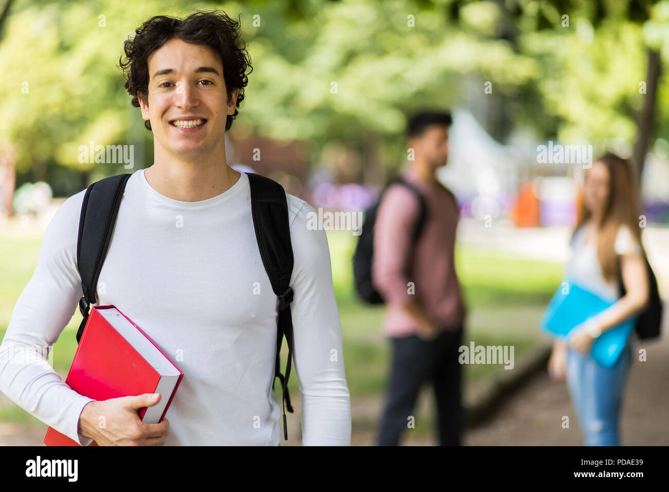 Happy students outdoor smiling Stock Photo - Alamy