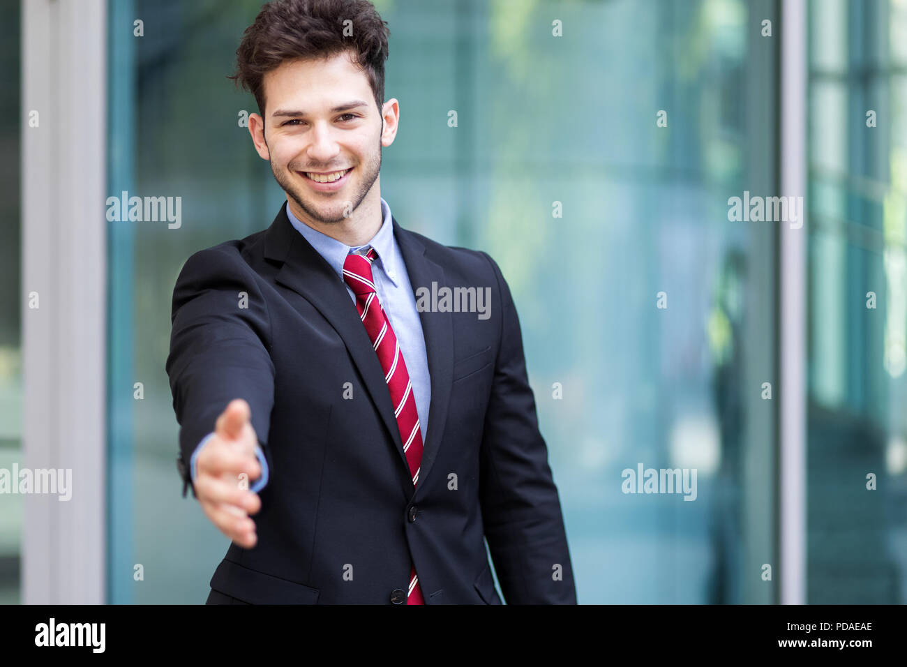 Businessman offering handshake to you hi-res stock photography and ...