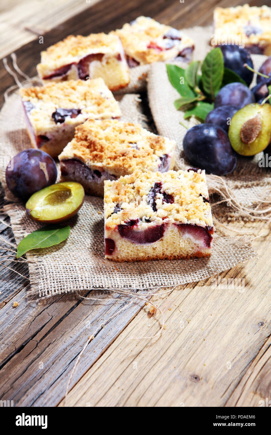 Rustic plum cake on wooden background with plums around Stock Photo - Alamy