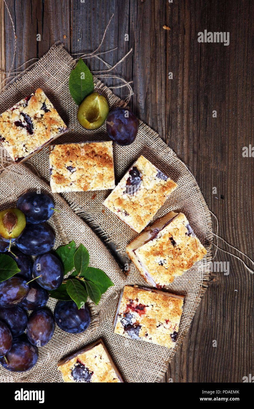 Rustic plum cake on wooden background with plums around Stock Photo - Alamy