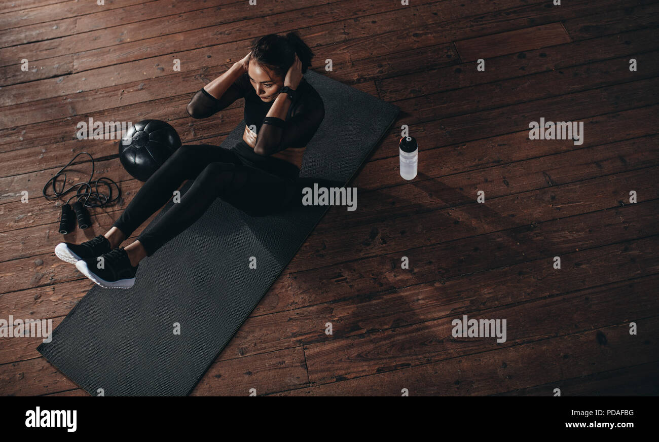 Top view of female doing abdomen workout at the gym. Fit woman on ...