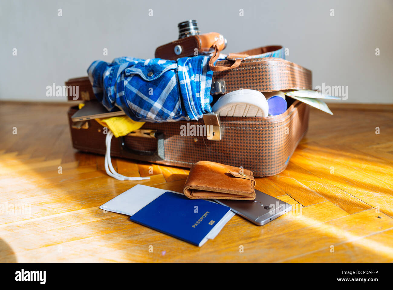 overloaded suitcase with clothes. travel concept. bag with garment ...