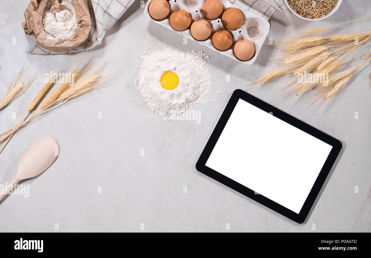 Natural ingredients for baking with tablet Stock Photo - Alamy