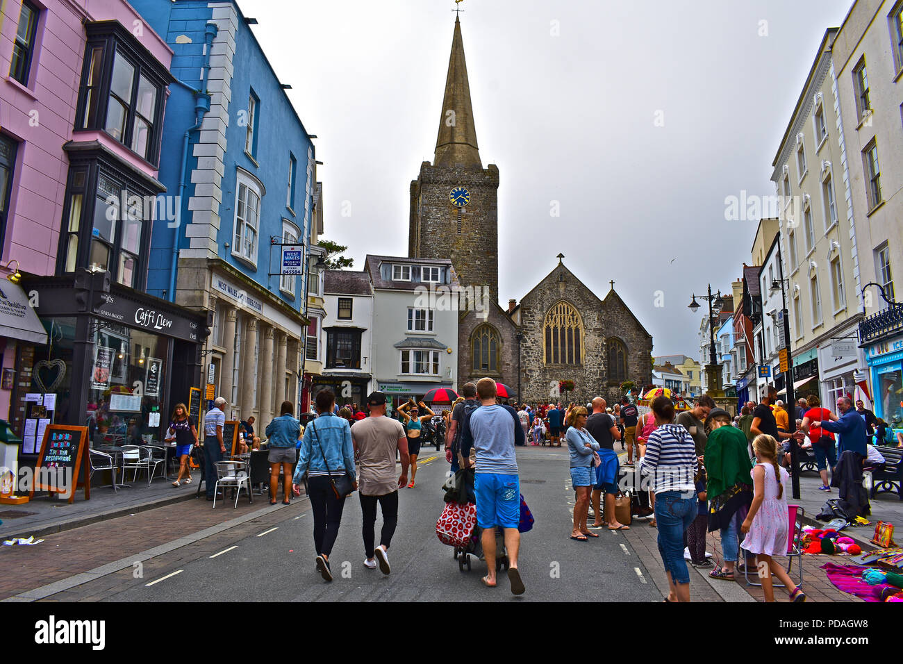 Holidaymakers throng the central streets of the pretty seaside resort ...