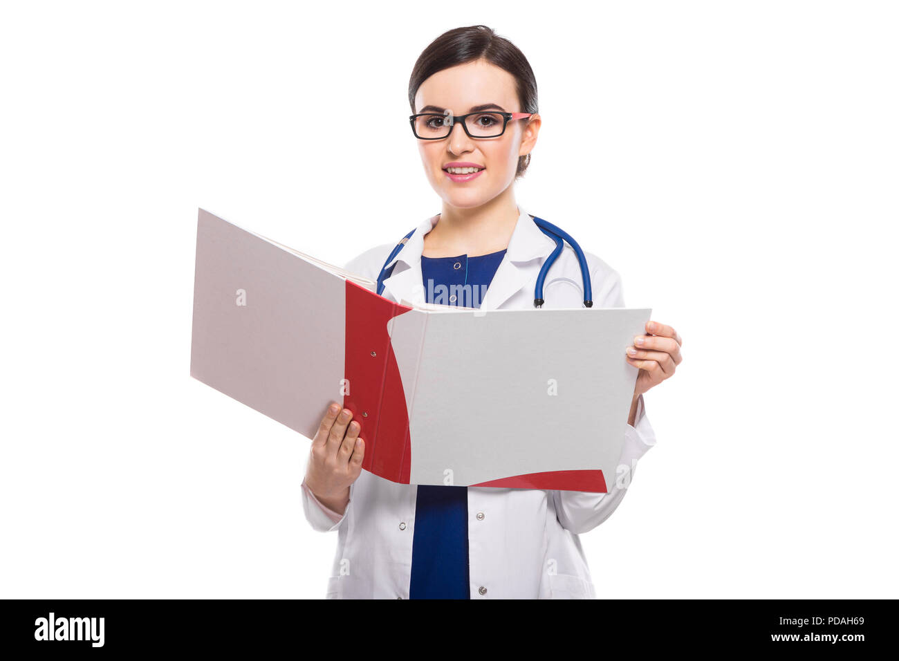 Young woman doctor with stethoscope holding binder in her hands in ...
