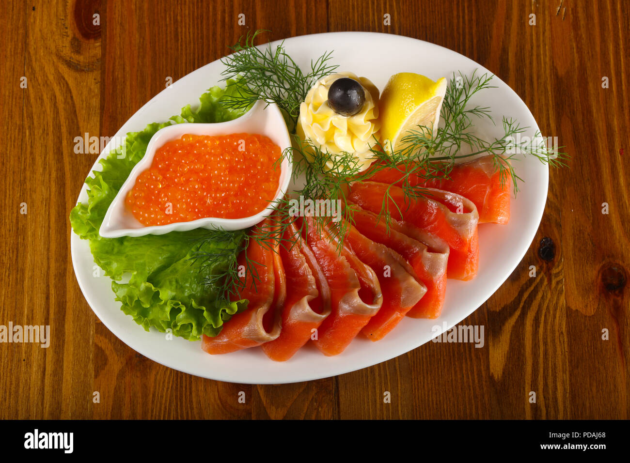 Sliced trout and red caviar served lemon Stock Photo - Alamy