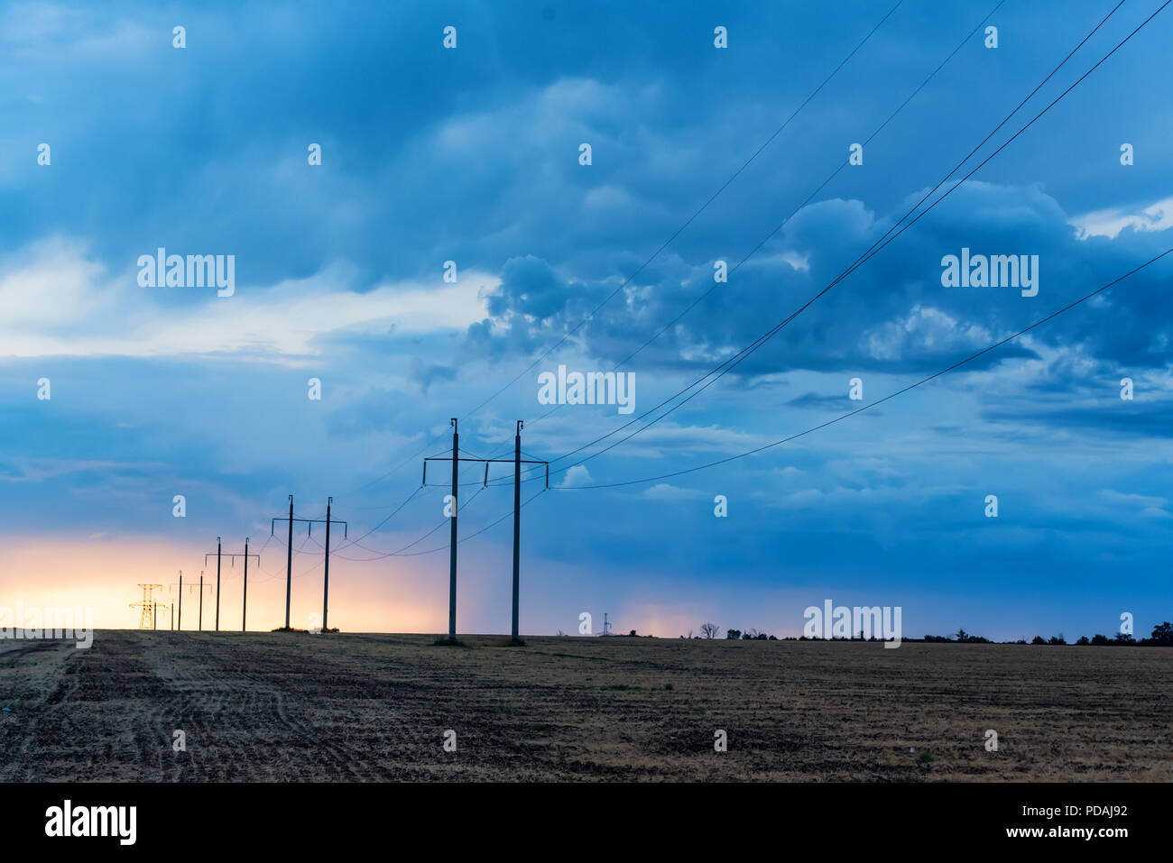 Rural landscape with power poles at sunrise Stock Photo - Alamy