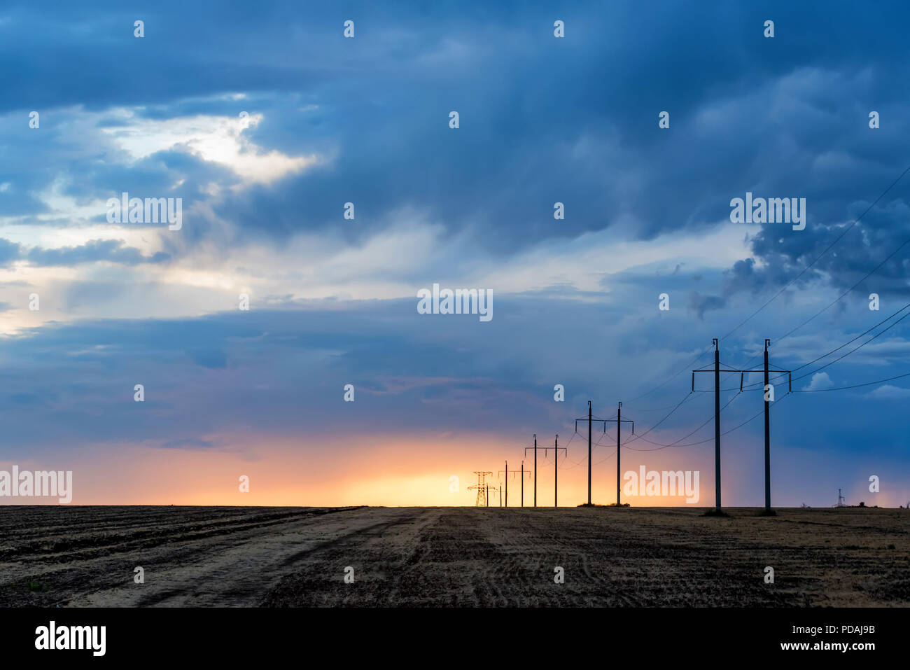 Rural landscape with power poles at sunrise Stock Photo - Alamy
