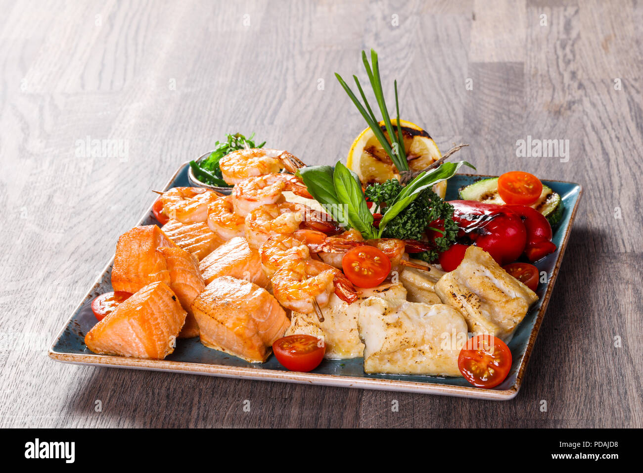 Fish and prawn plate served grilled vegetables Stock Photo - Alamy