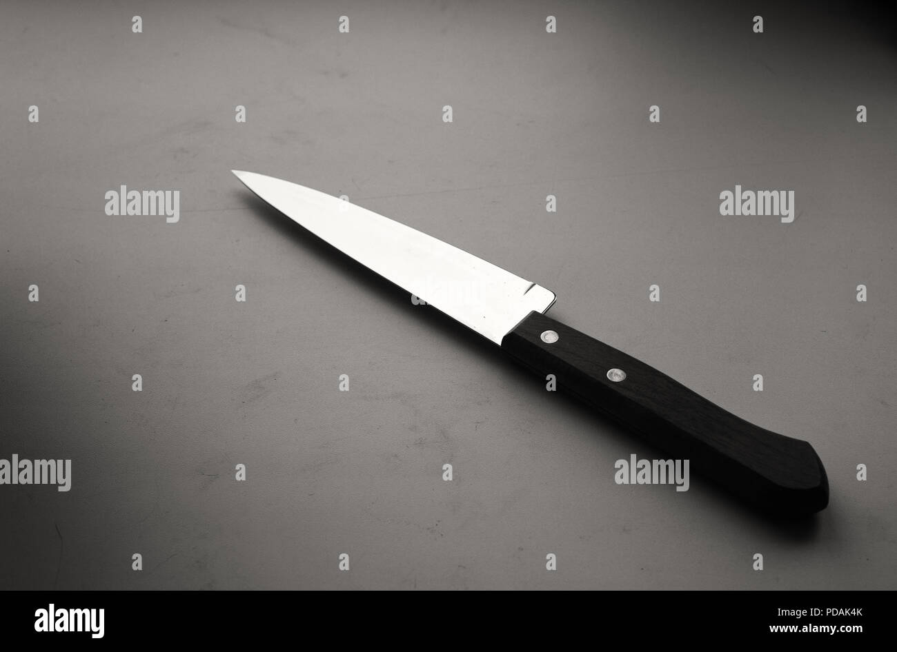 Sharp single kitchen knife in black and white with a wooden handle and ...