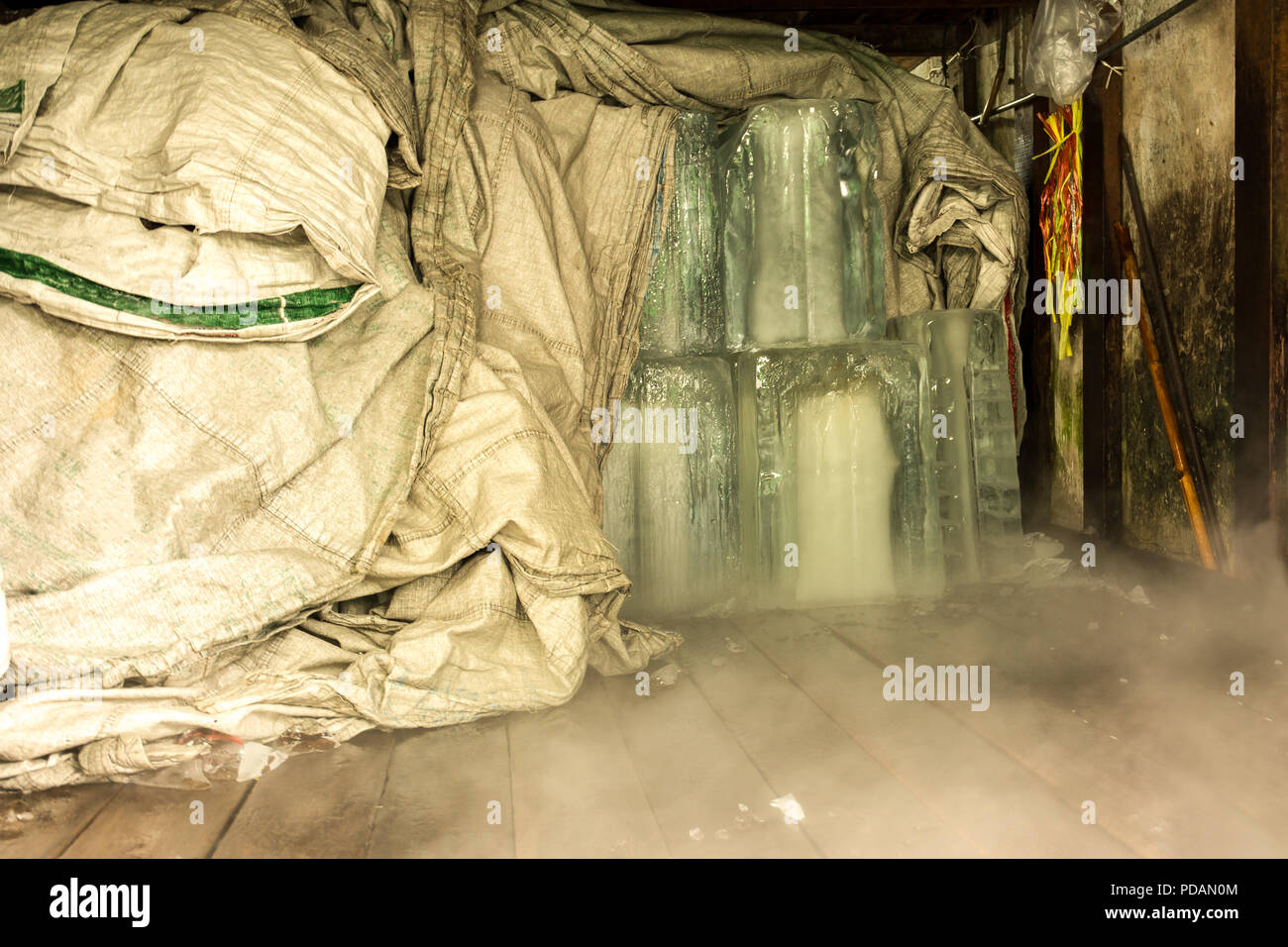 Large cubes of clear ice cover with plastic sack in ice factory Stock ...