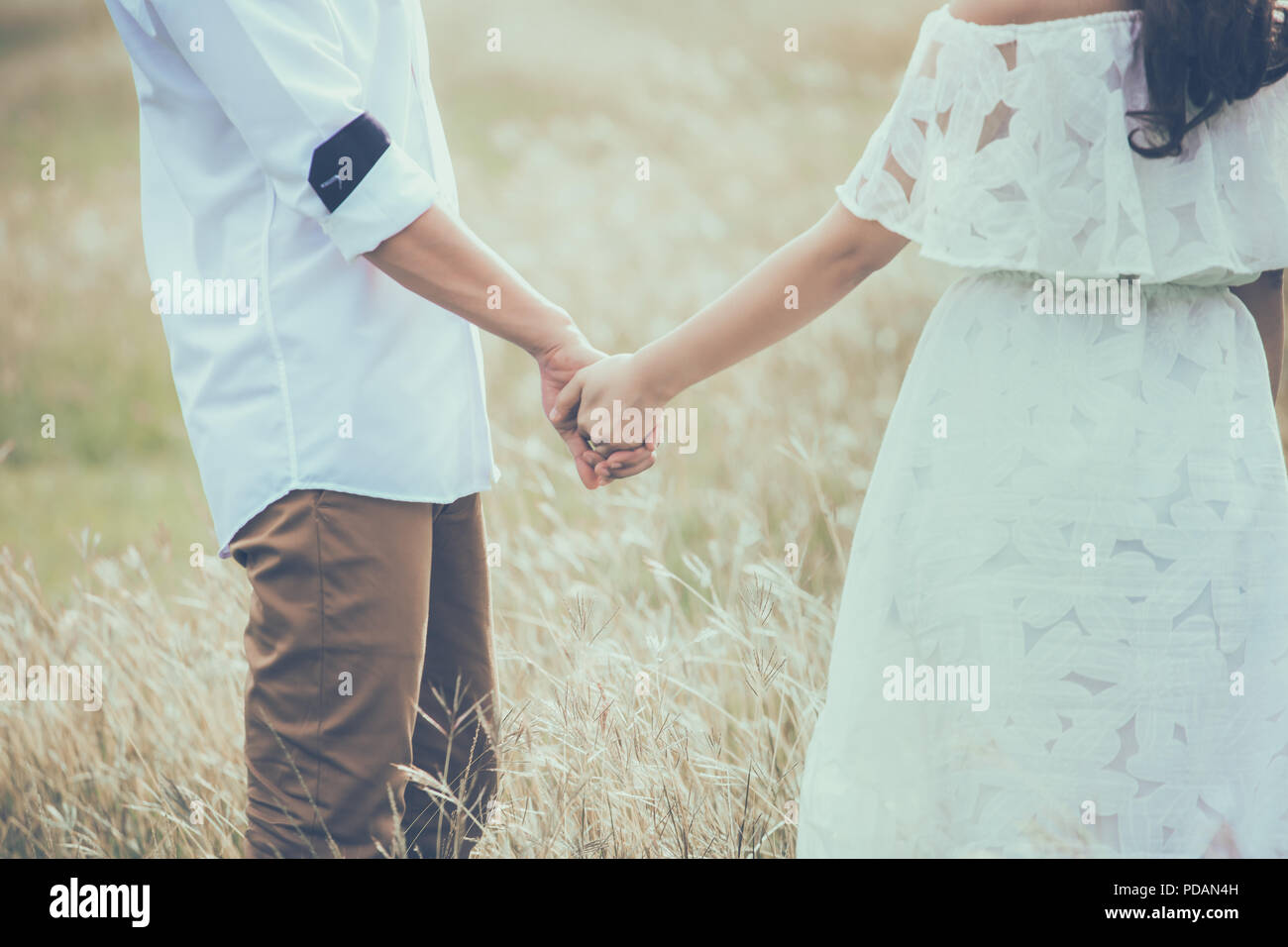 Young express love with a handshake as a symbol of love and marriage ...