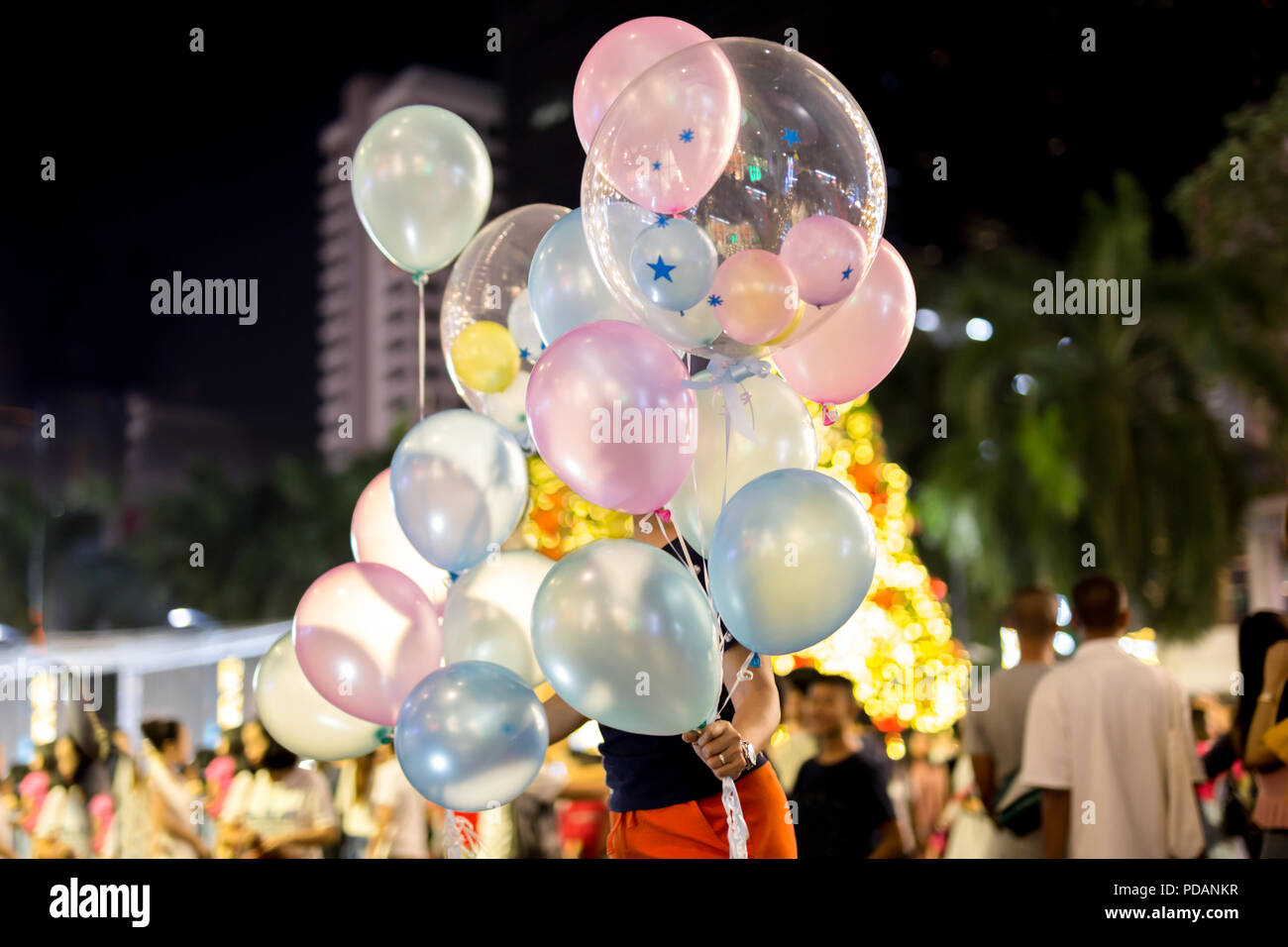 Woman holding balloon with birthday text on it in blur background Stock ...