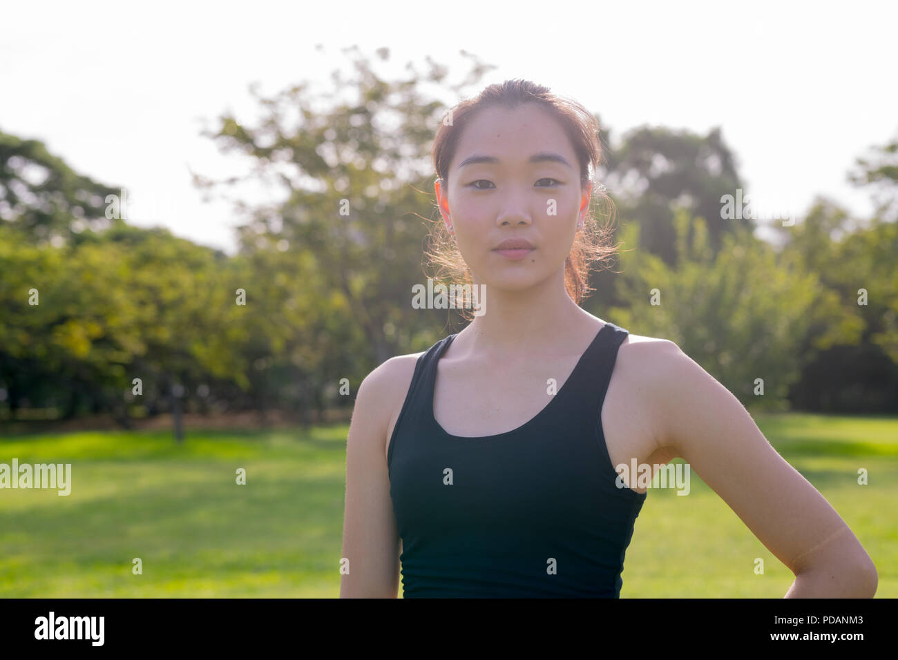 Portrait Of Beautiful Chinese Woman Ready For Exercise In Park Stock ...