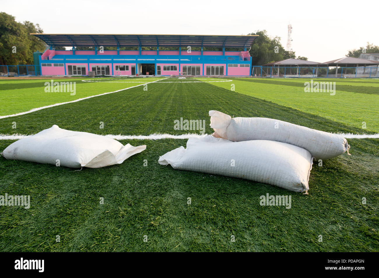White sack on new soccer field with light and dark green artificial ...