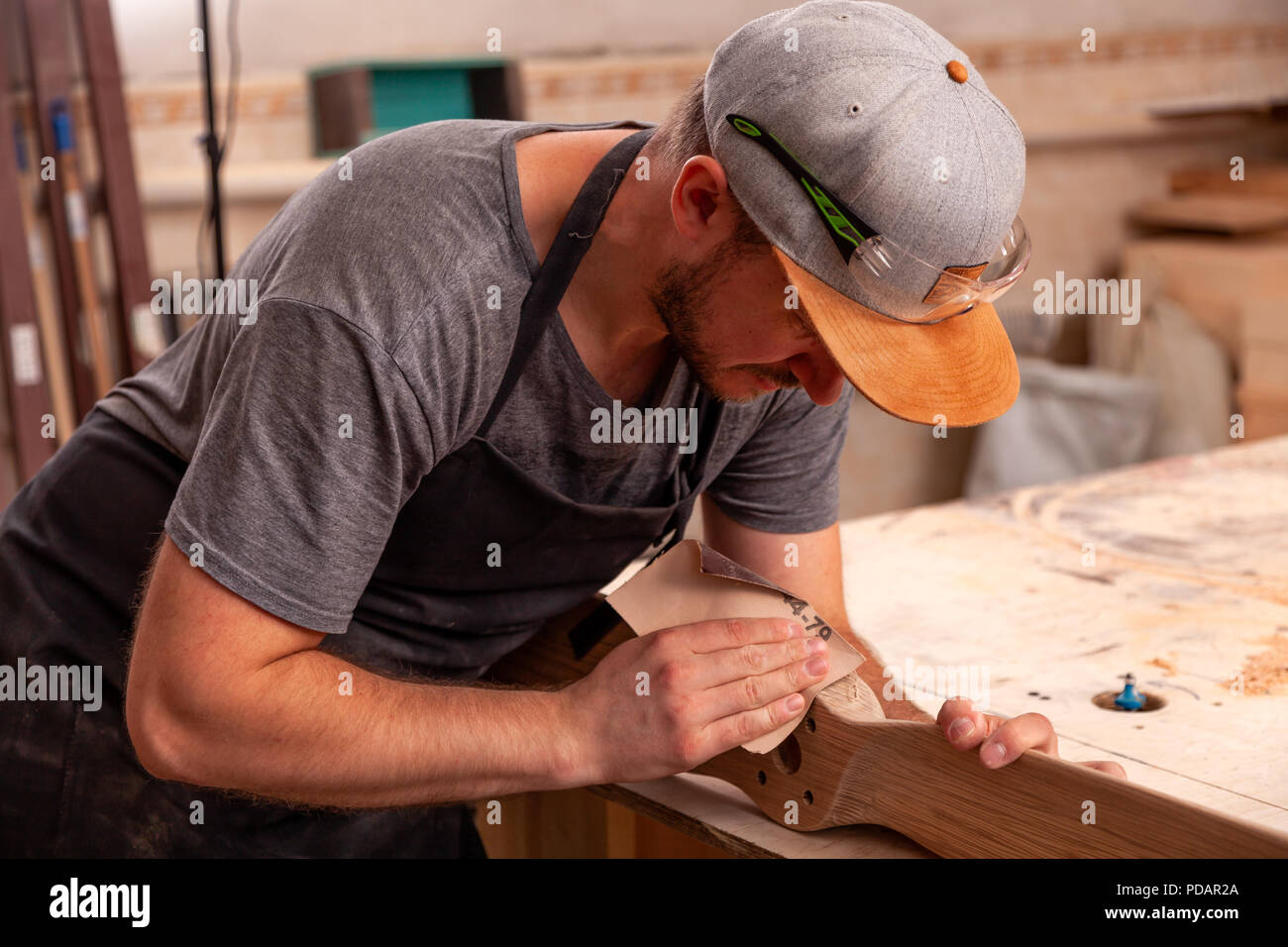 Experienced carpenter in work clothes and small buiness owner working ...