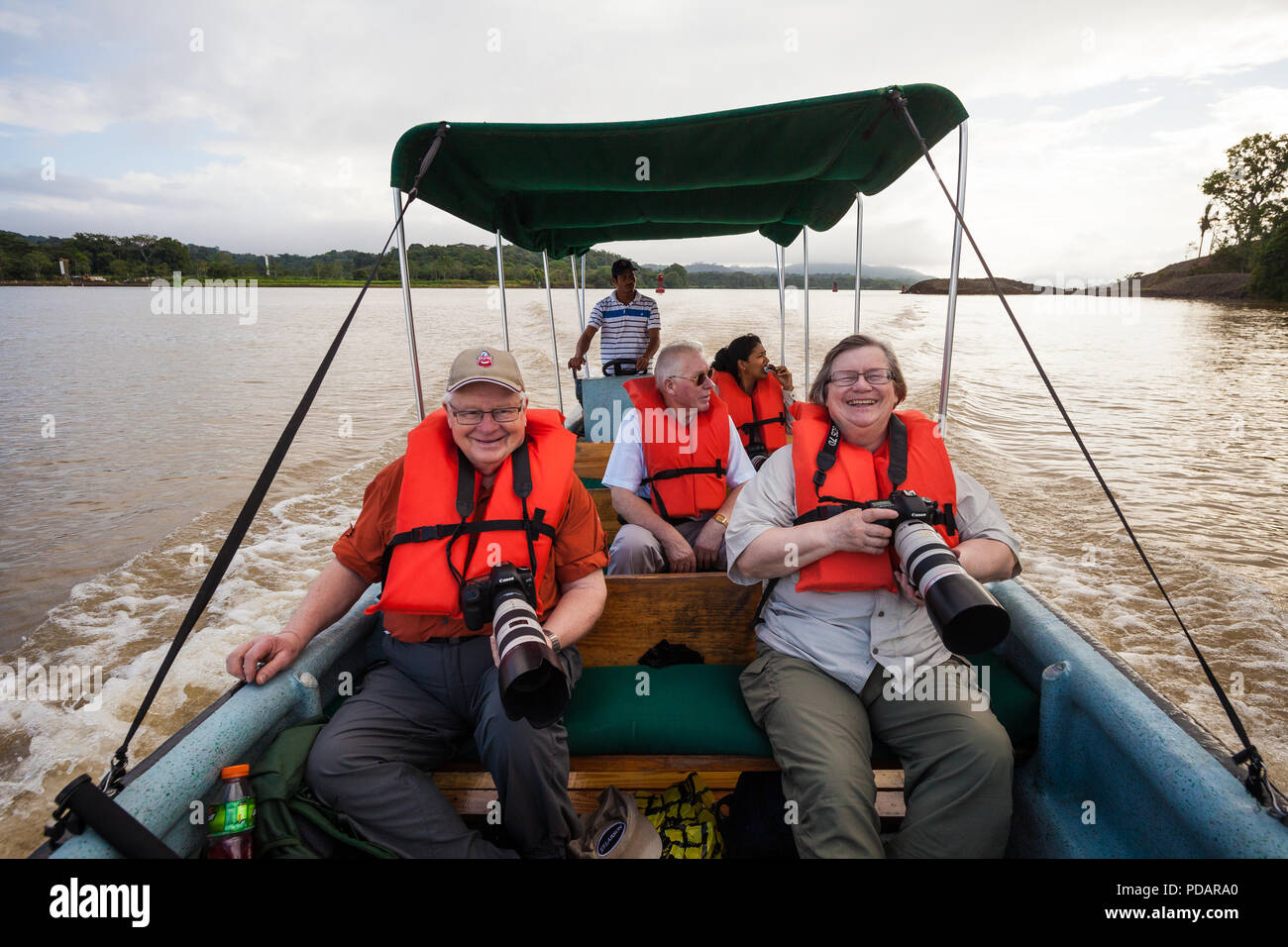 Happy nature tourists in a small boat on the Panama Canal, Republic of ...