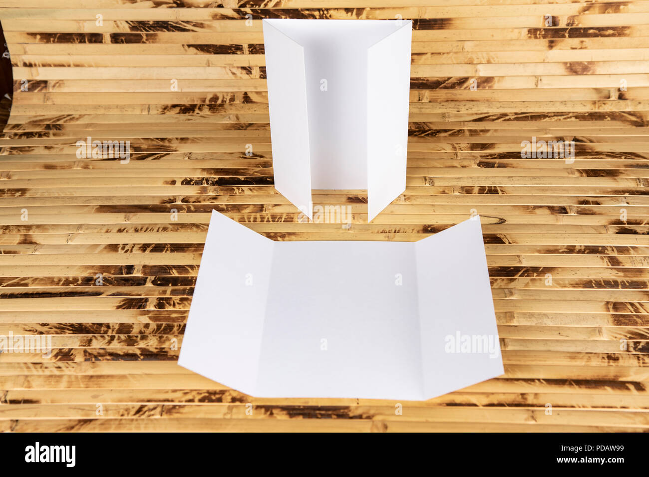 Blank gate fold brochure on bamboo background to replace your design ...