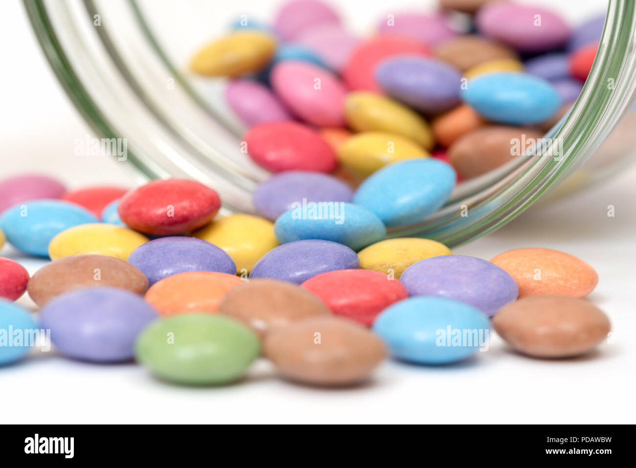 Close up of colorful sugar coated candies spillng from a jar Stock ...