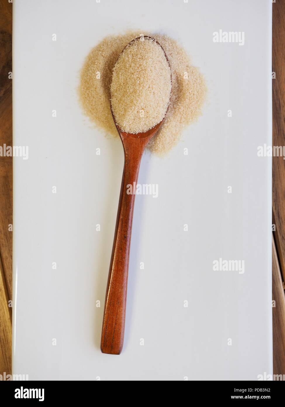 Brown powdered sugar in a spoon Stock Photo - Alamy