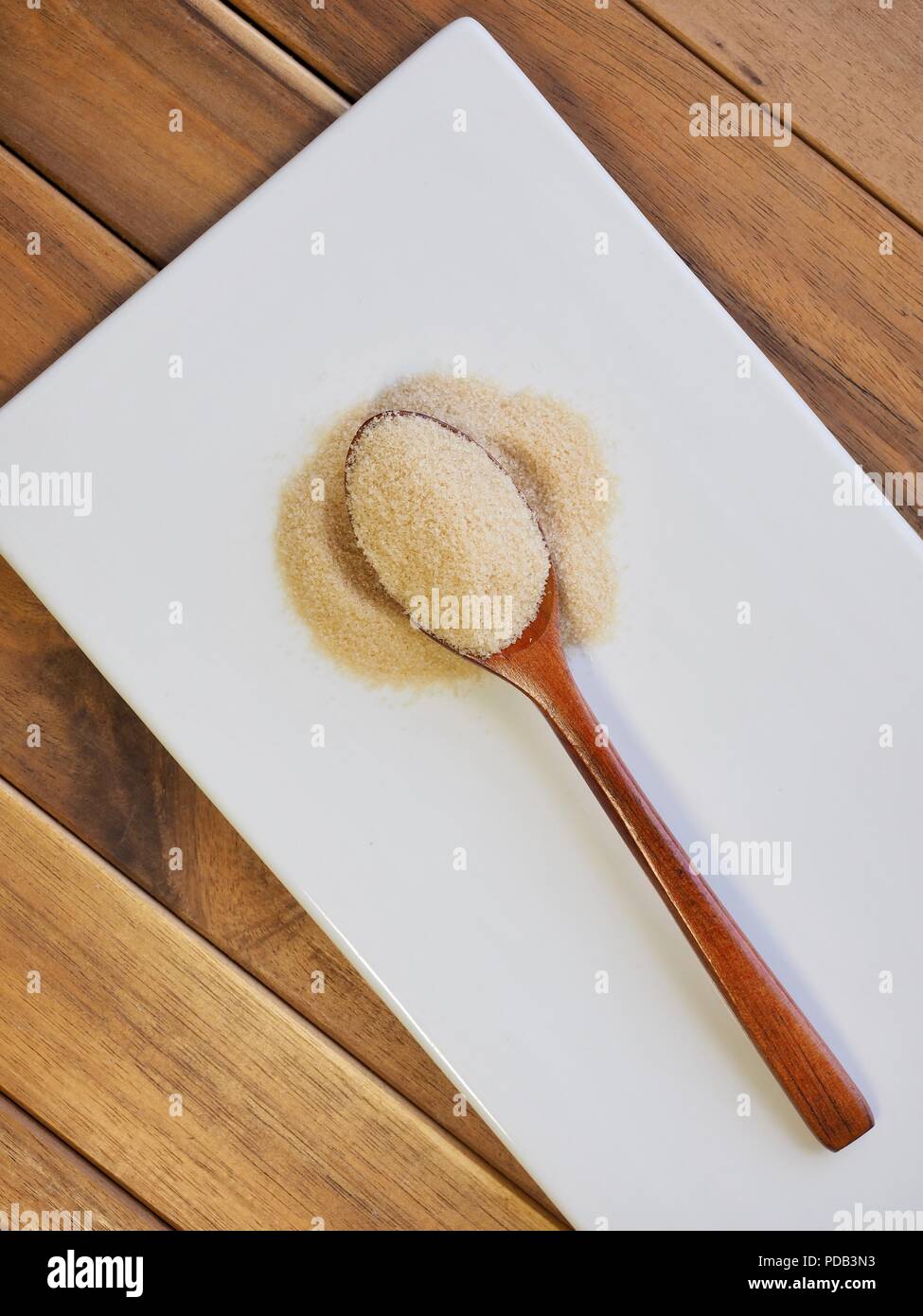 Brown powdered sugar in a spoon Stock Photo - Alamy