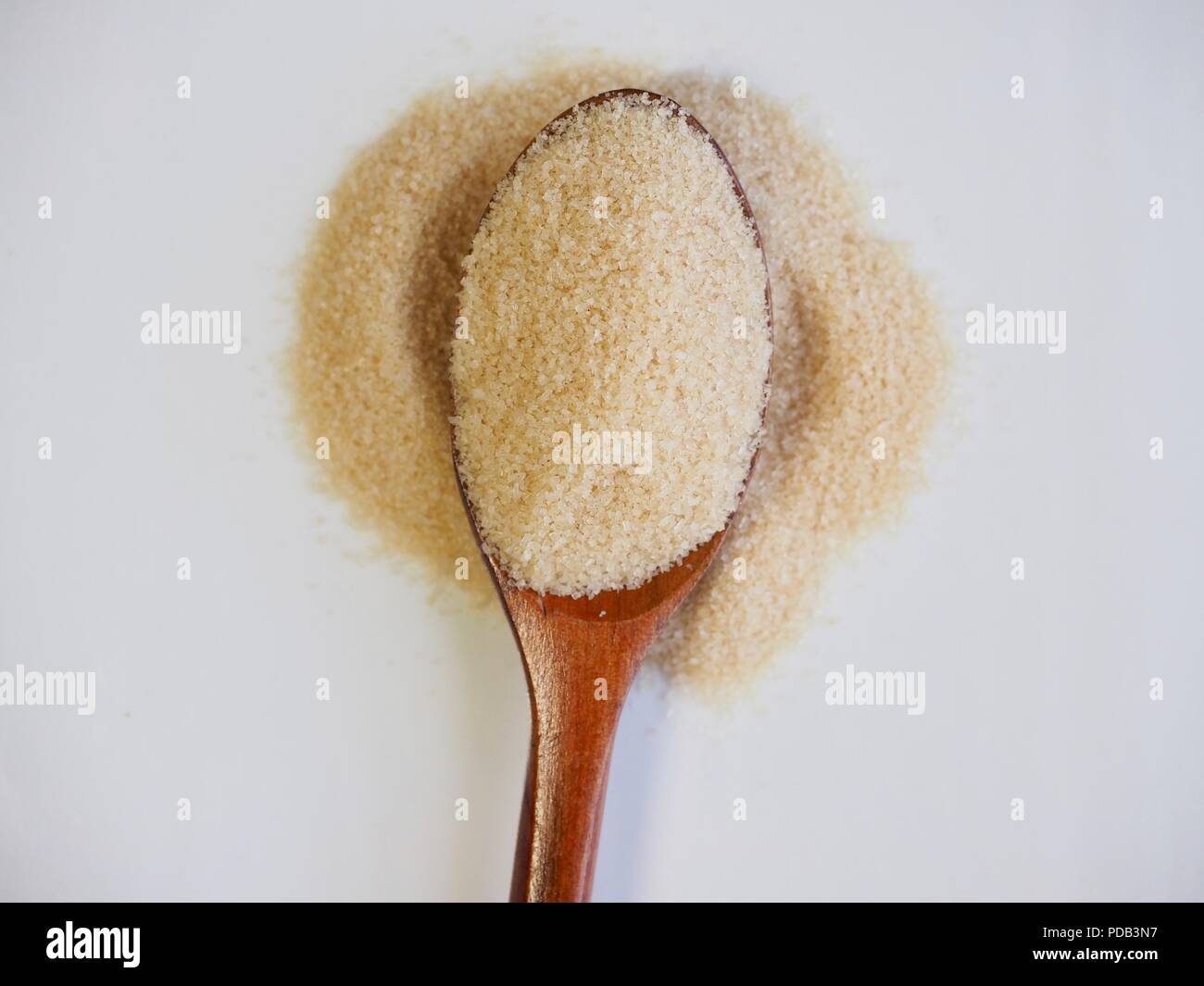 Brown powdered sugar in a spoon Stock Photo - Alamy