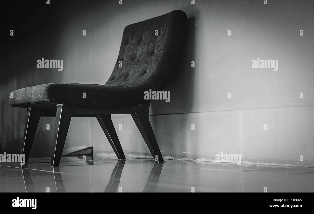 Black classic chair with unique design in empty rest room near concrete ...