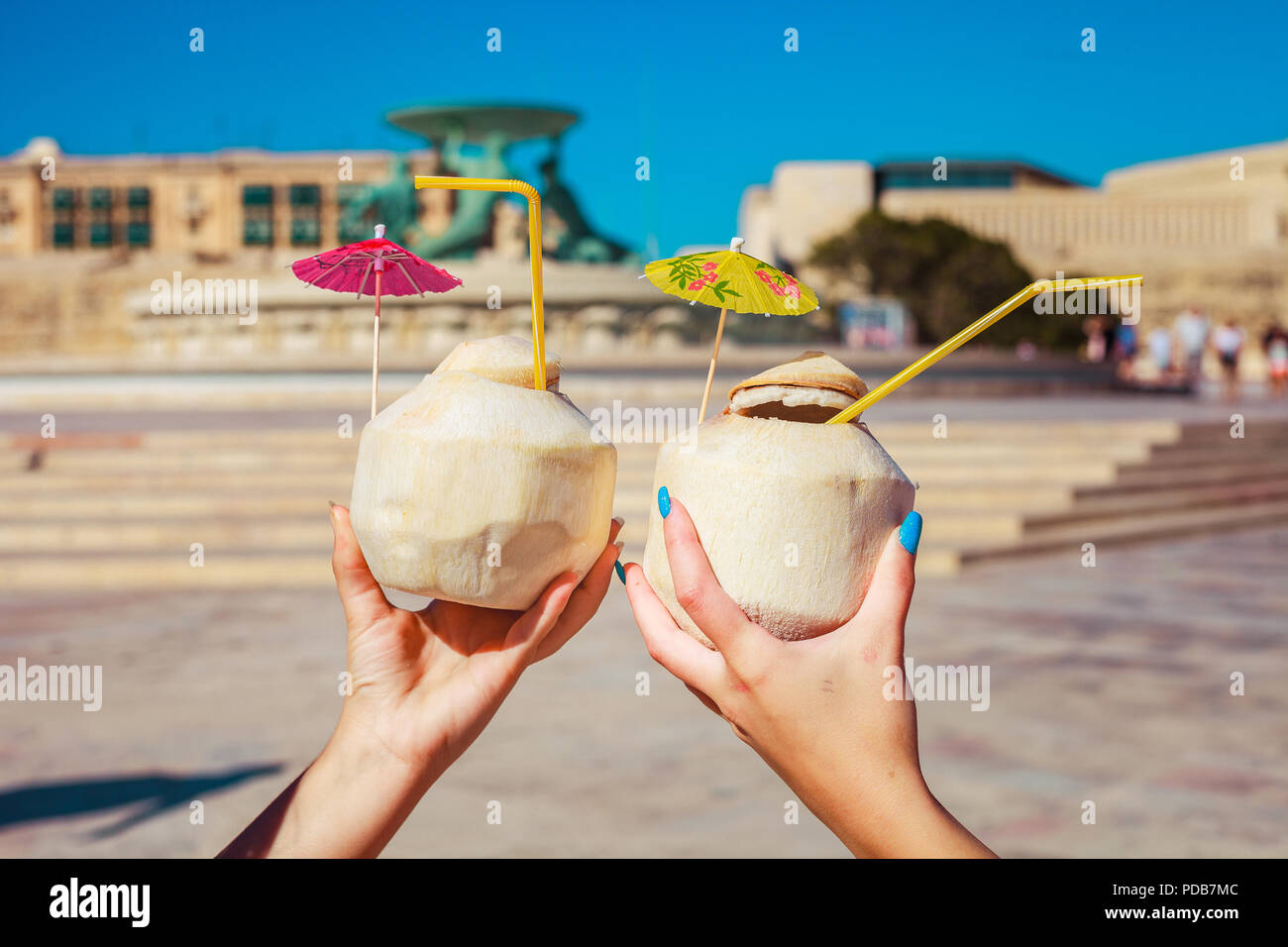 Women holding up coconut drinks in Valletta, Malta Stock Photo - Alamy