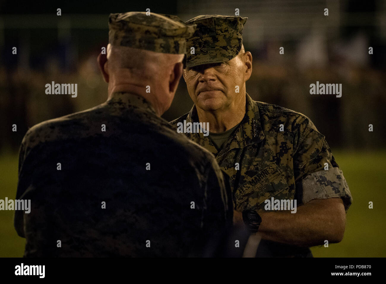 Commandant of the Marine Corps Gen. Robert B. Neller (right) hands the ...