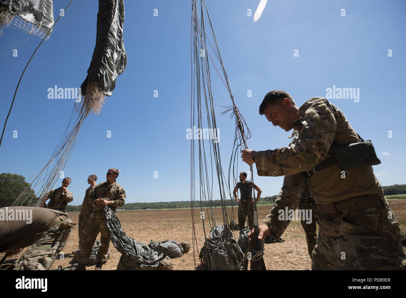 U.S. Army Staff Sgt. Justin Morelli untangles the static lines of his ...