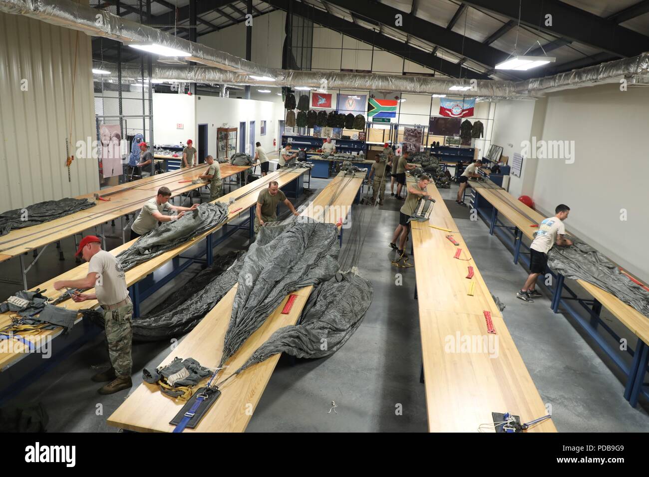 A group of U.S. Army Riggers repack the MC-6 parachute at Building 216 ...