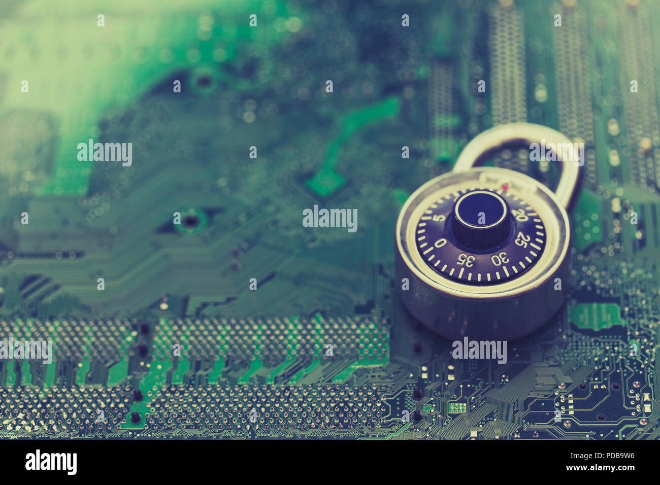 Padlock on a computer electronic circuit board. Data technology ...