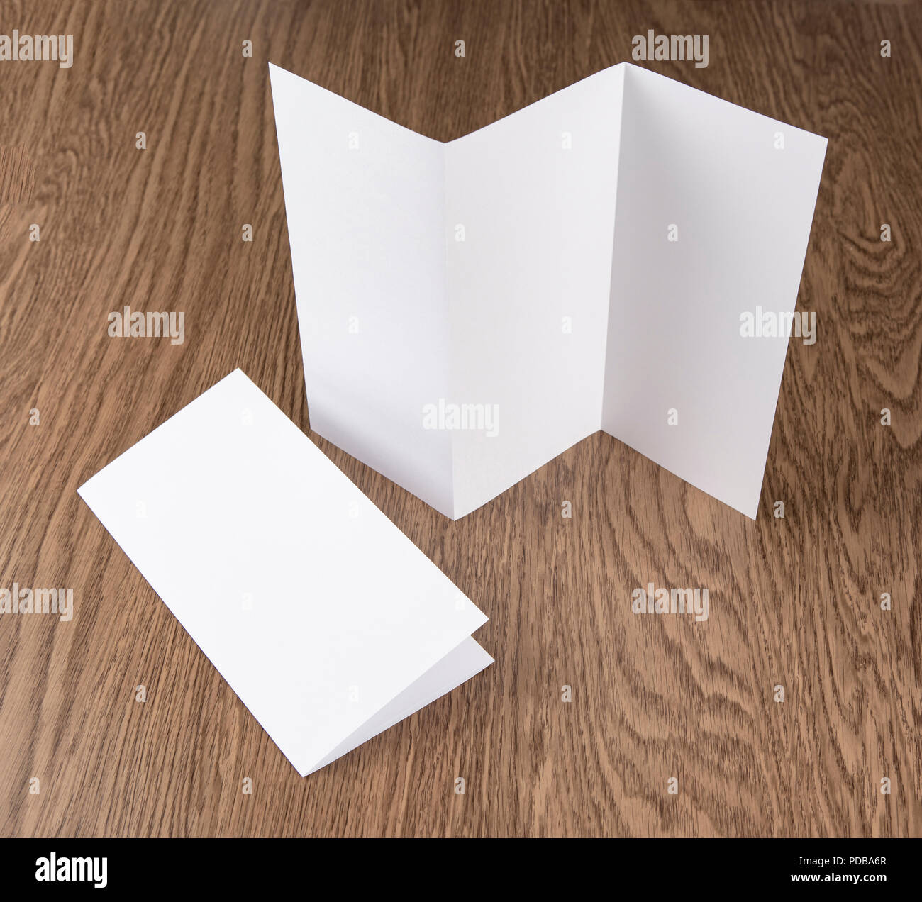 Mockup of white booklet on wooden background Stock Photo - Alamy