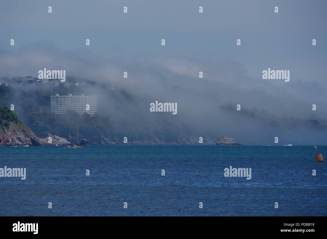 Advection Sea Fog Rolling over Cliff and Hotel by the Blue Sea. English ...