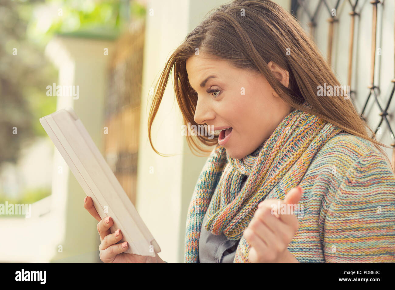 Woman reading tablet device reaction hi-res stock photography and ...