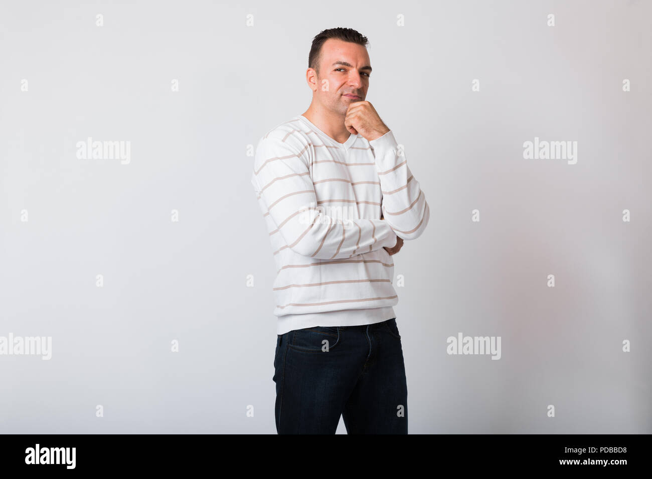 Portrait Of Handsome Man Thinking Against White Background Stock Photo ...