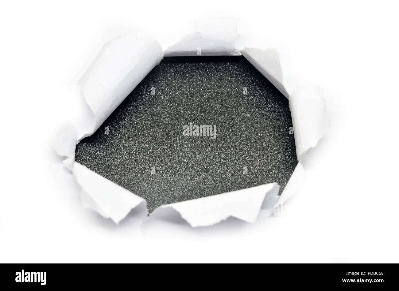 Hole in the paper with torn side, isolated Stock Photo - Alamy