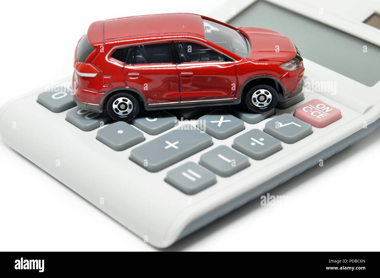 Calculator and toy car isolated on white background Stock Photo - Alamy