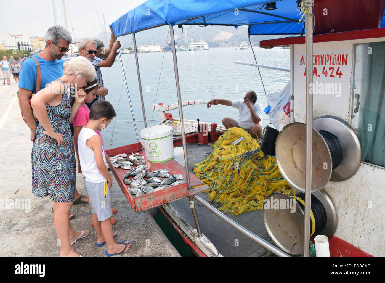 Fisherman selling fish direct from his boat, Argostoli, Kefalonia ...