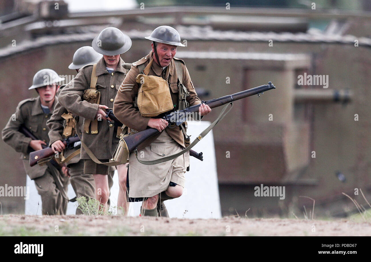 World War One living history actors take part in a mock battle during ...