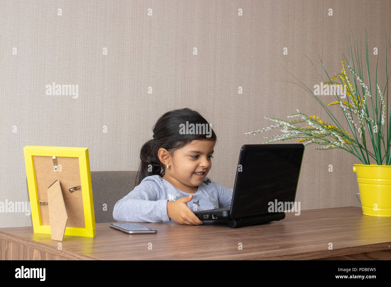 Cute little girl working in the office Stock Photo - Alamy