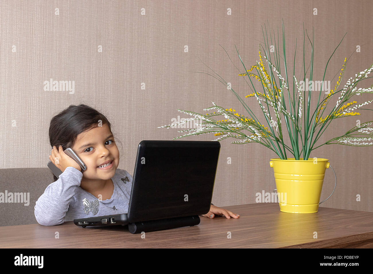 Cute little girl working in the office Stock Photo - Alamy
