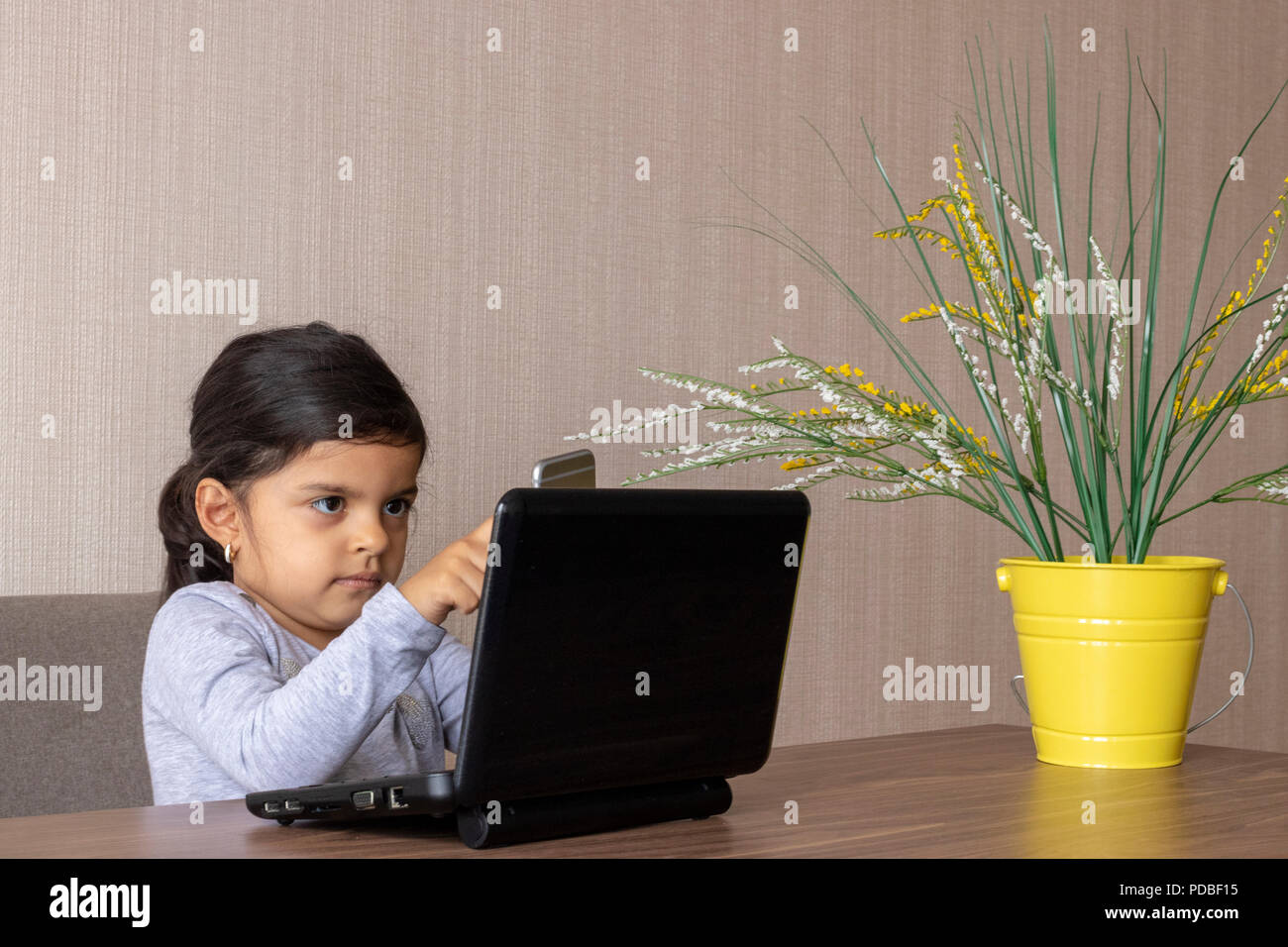 Cute little girl working in the office Stock Photo - Alamy